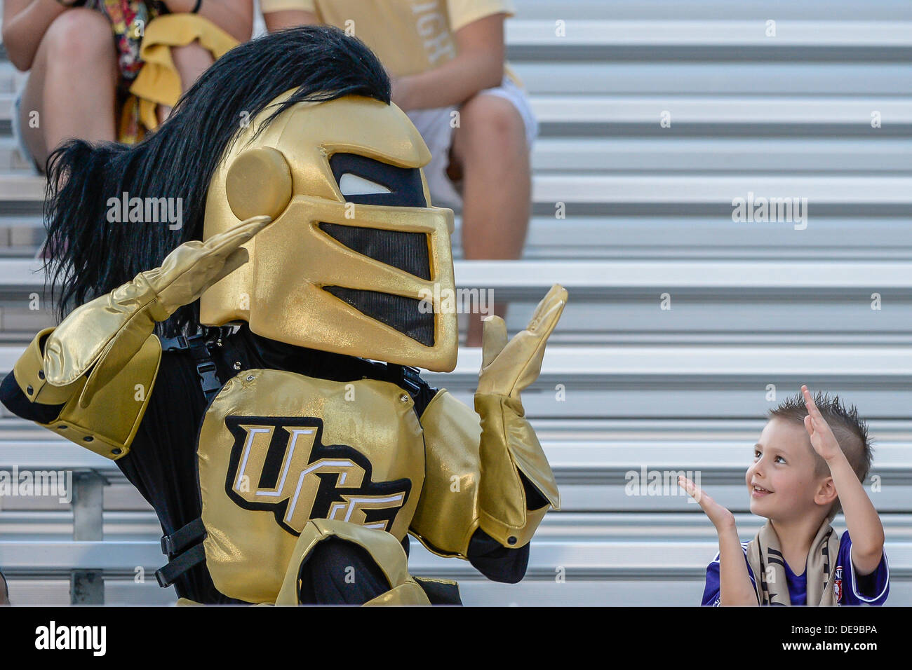 Orlando, FL, USA. 13th Sep, 2013. UCF Mascot Knightro shows a young ...
