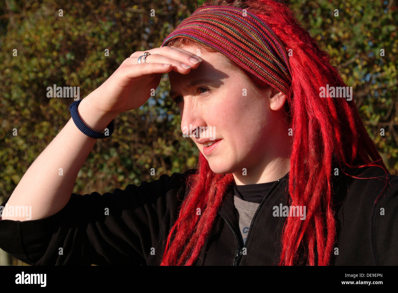 Young woman with long dyed red hair, dreadlocks Stock Photo - Alamy