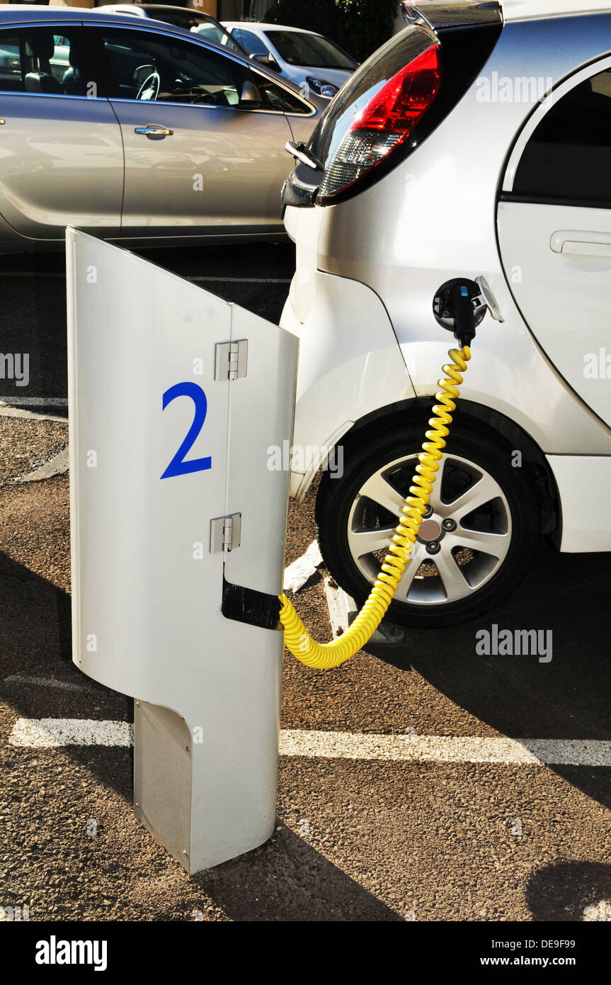 Detail of electrical car in charging position connected to an electric ...
