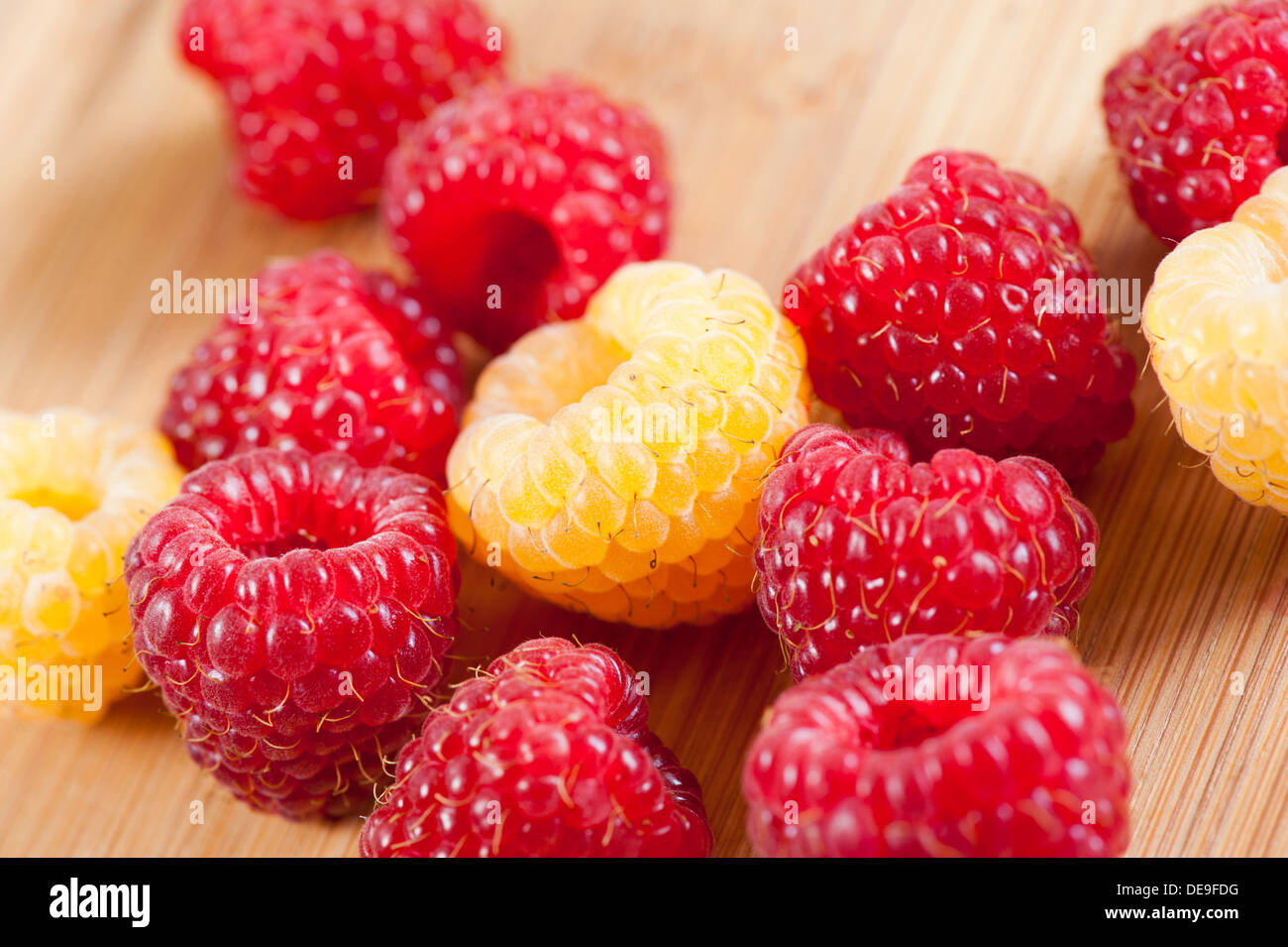 fresh golden and red raspberries fruits Stock Photo - Alamy