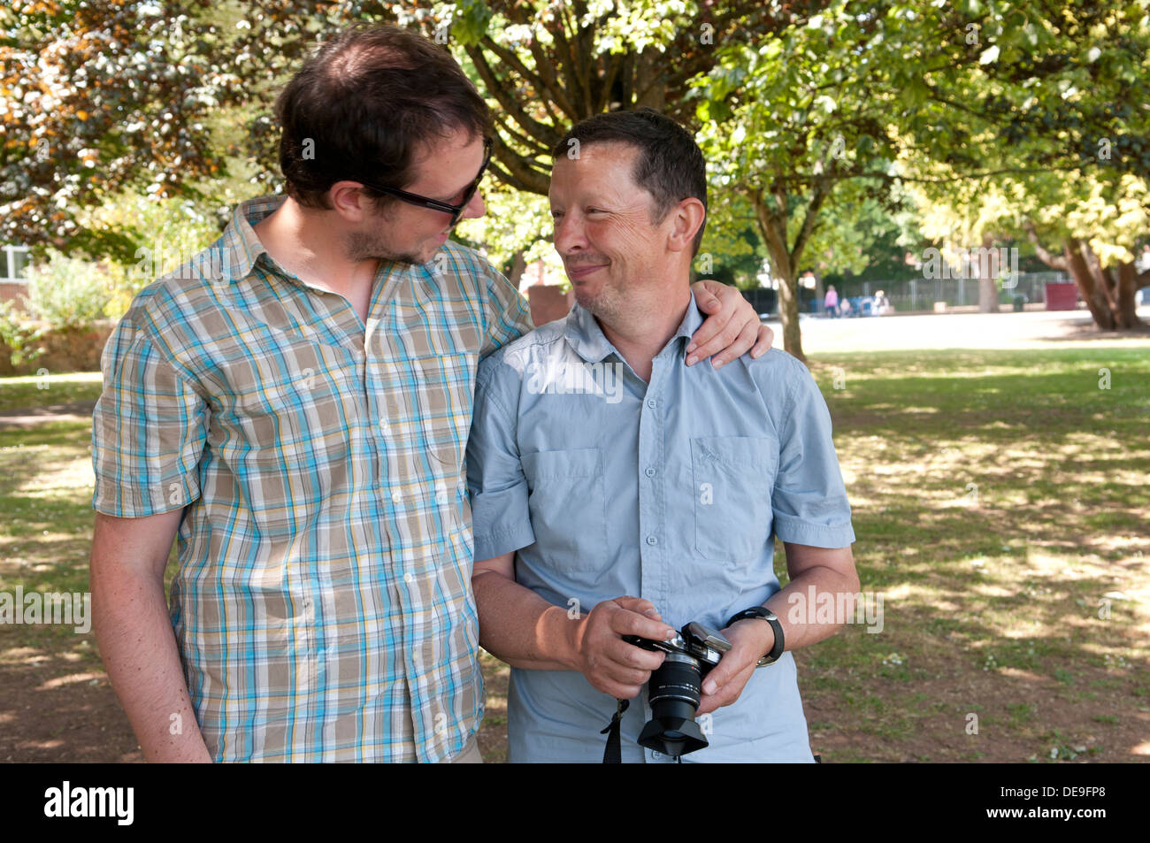 Man with his arms around his father Stock Photo - Alamy
