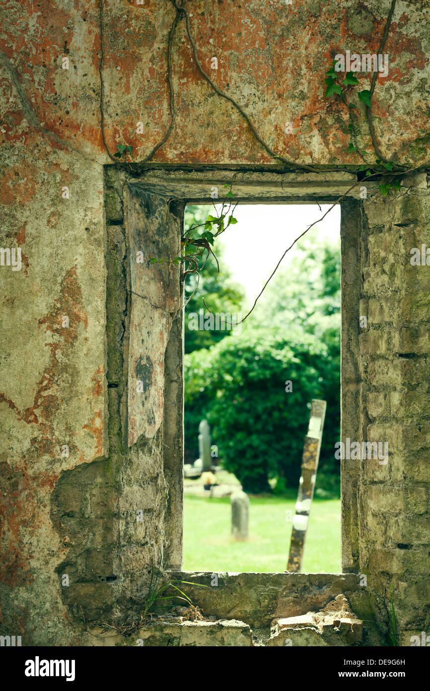 Graveyard seen through the window of the ruins of the church at Lackagh ...