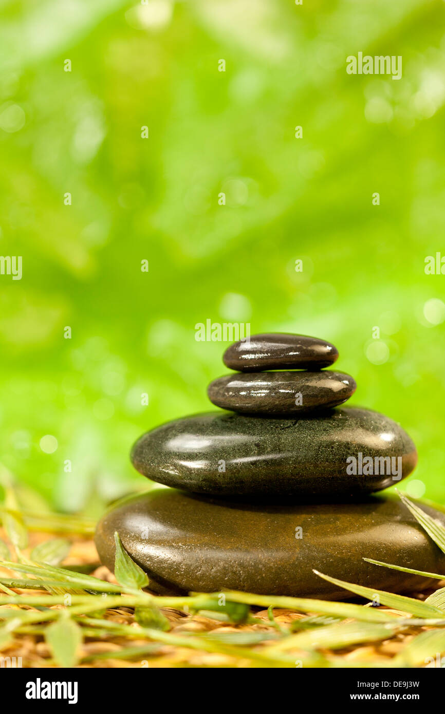 Spa Massage Hot Stones in Natural Green Environment Stock Photo - Alamy