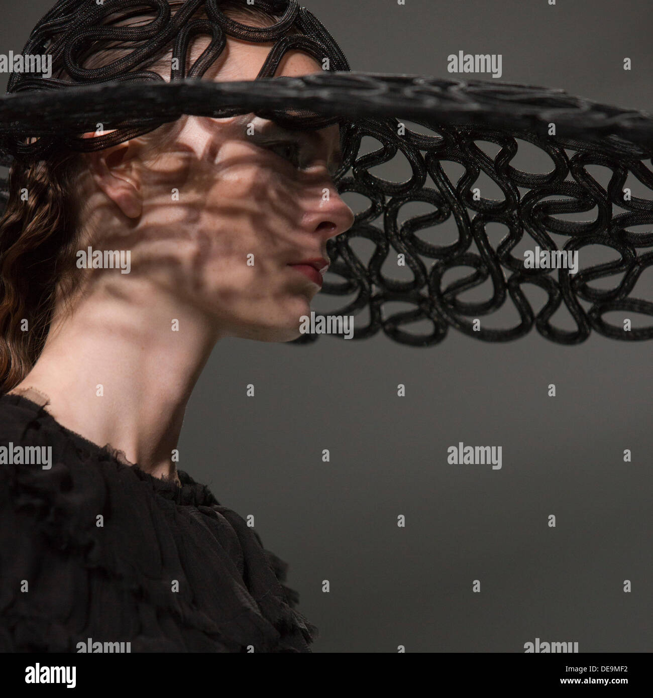 London, UK. 14th Sept, 2013.A model walks the runway at the John Rocha ...