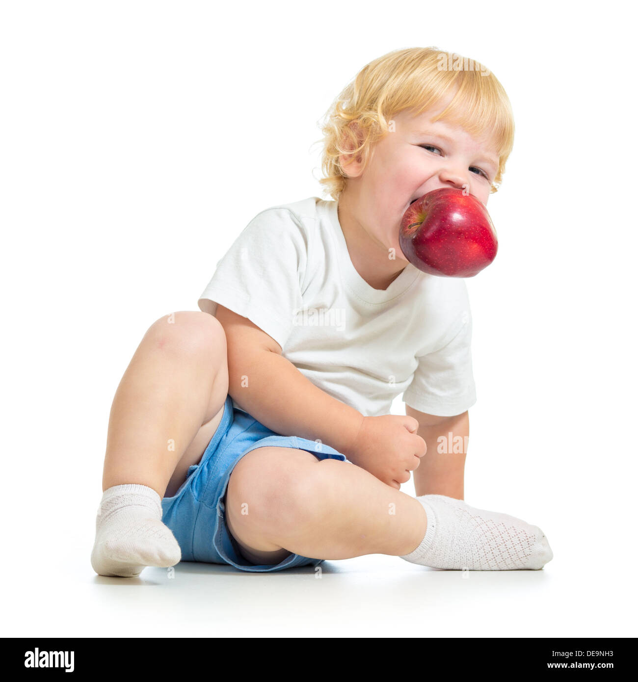 kid holding apple in mouth Stock Photo - Alamy