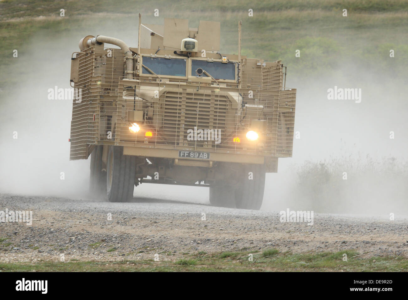 A British Army Mastiff patrol vehicle at speed creates a dust cloud on ...