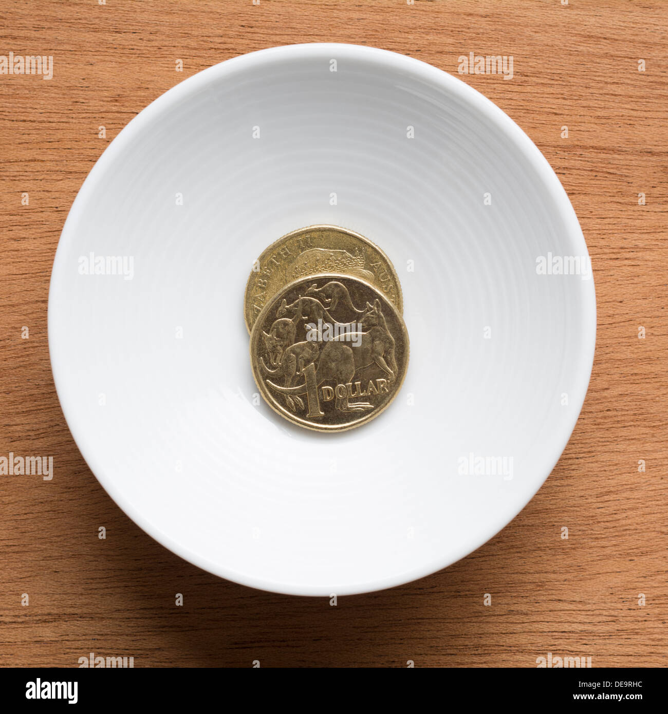 Bowl filled with Australian dollar coins Stock Photo - Alamy
