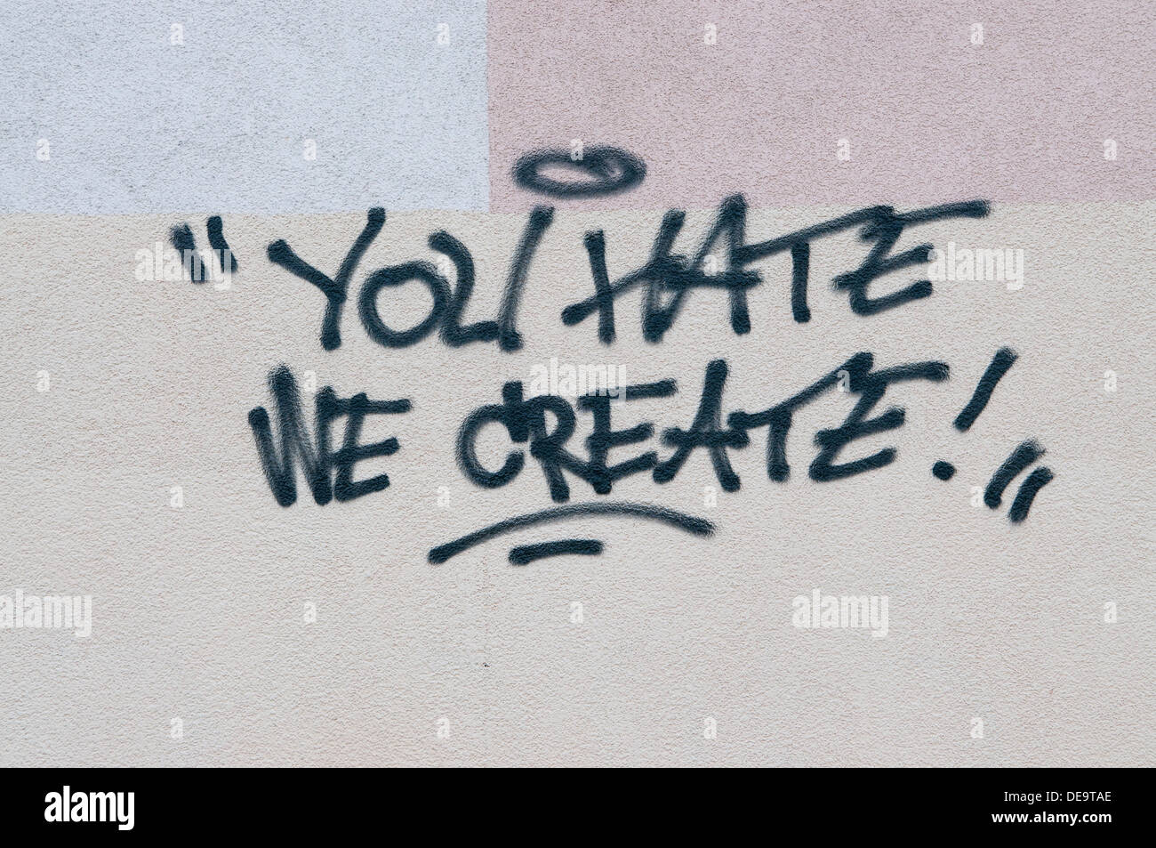 "You Hate we create" graffiti on the wall of apartments building in ...