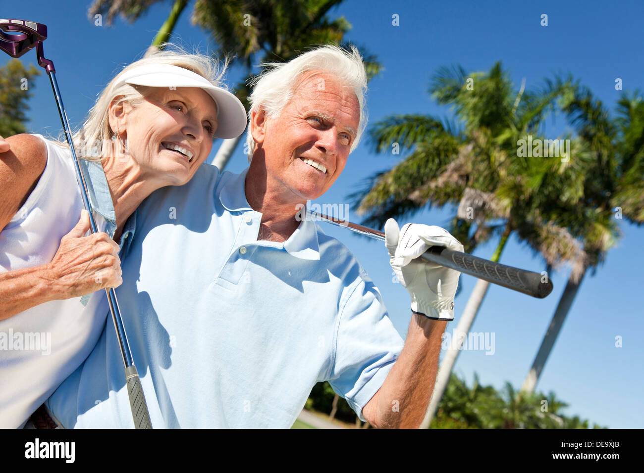 Happy senior man and woman couple together playing golf together on ...