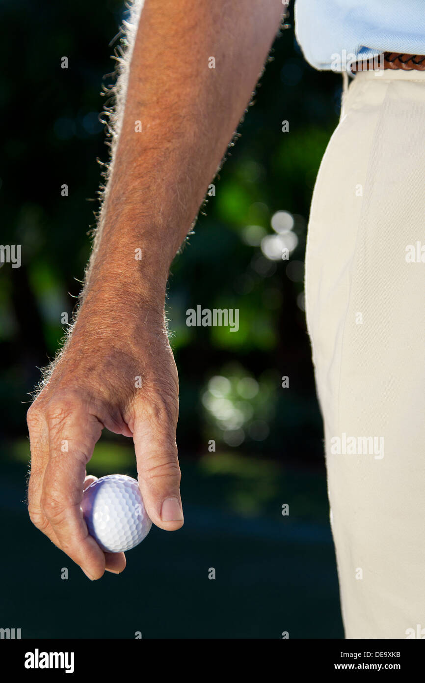 Close up on male golfer's gloved hand holding a golf ball Stock Photo ...