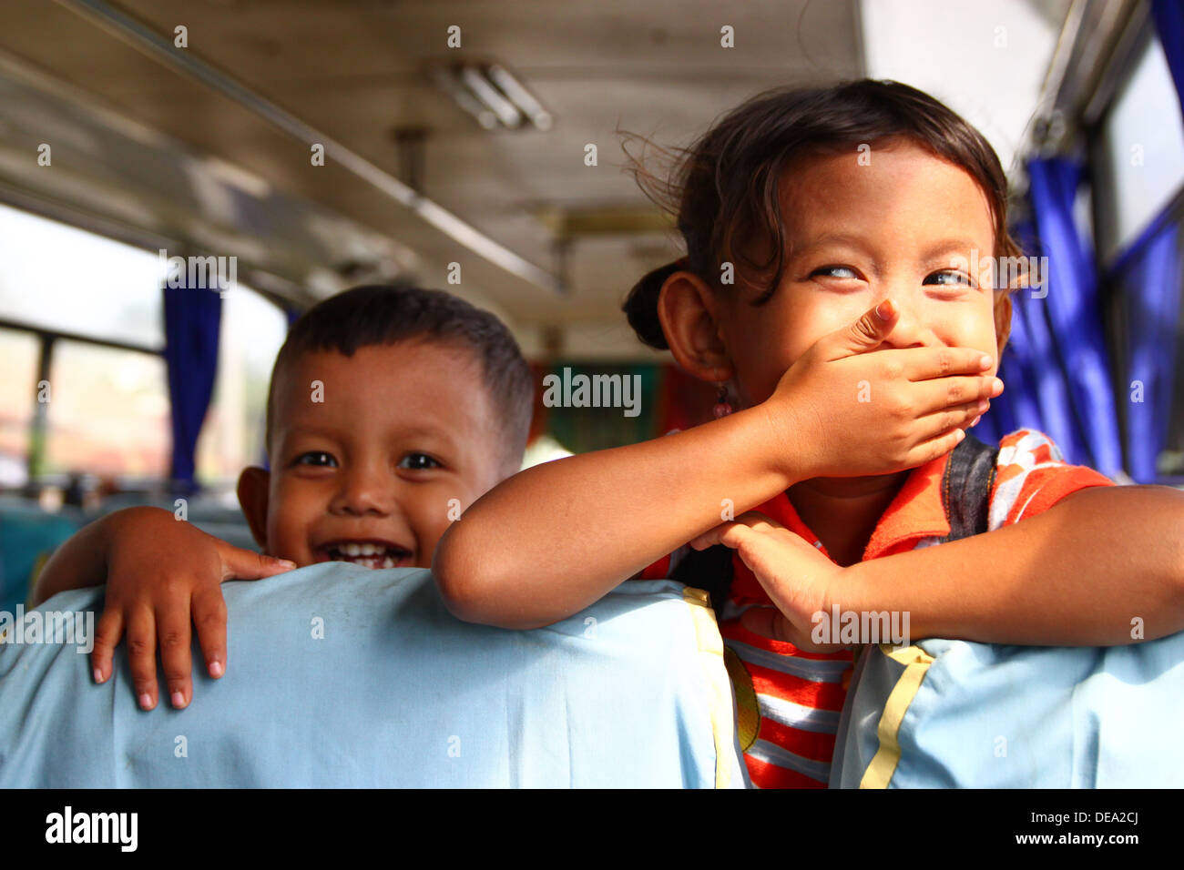 Two children on a bus in North Sumatra, Indonesia Stock Photo - Alamy