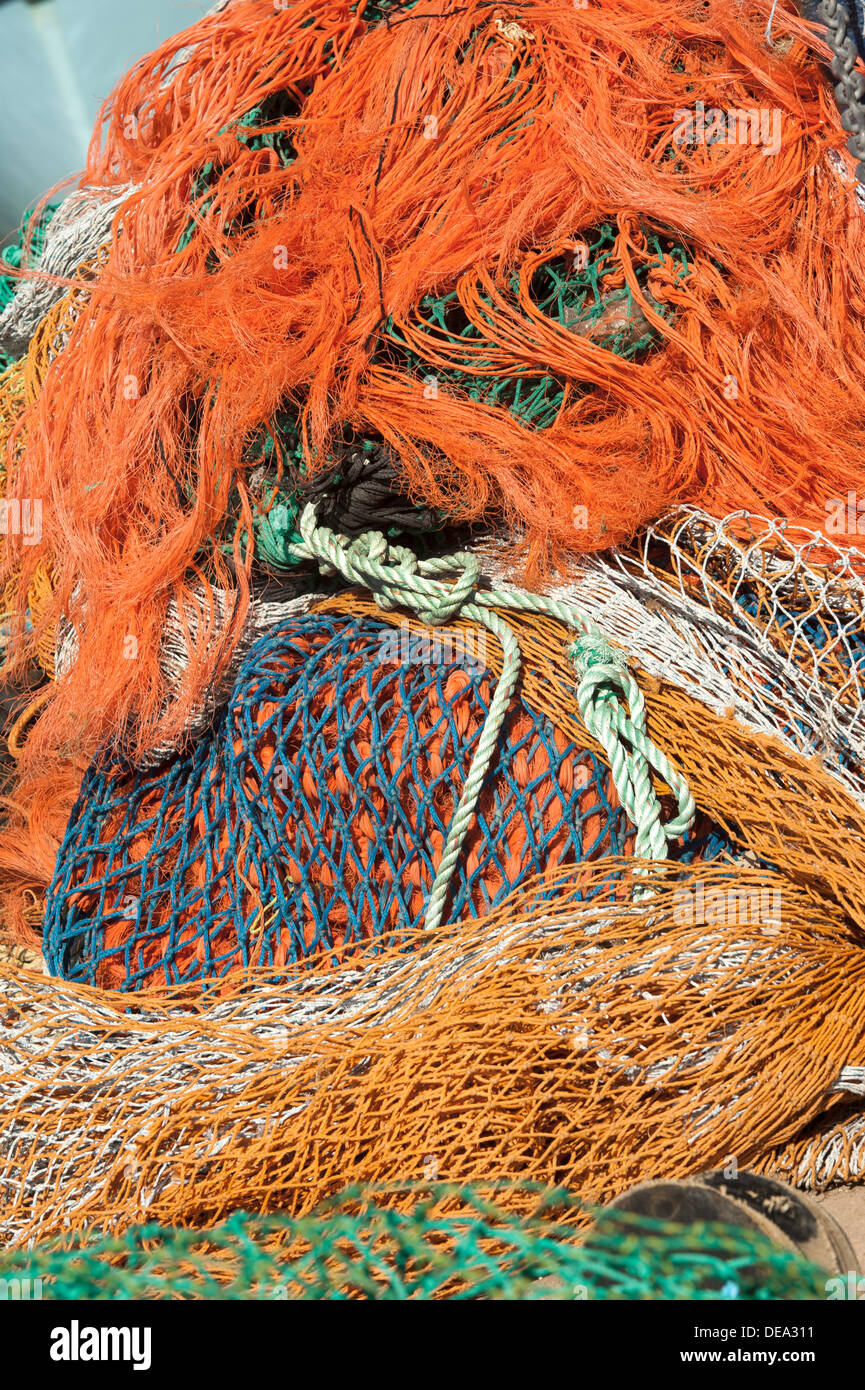 A pile of colourful tangled fishing nets and rope piled up Stock Photo ...