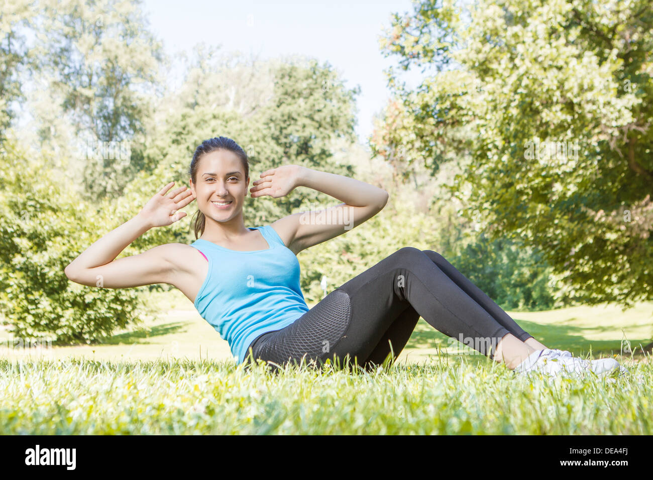 Happy fitness girl doing exercise outdoor Stock Photo - Alamy