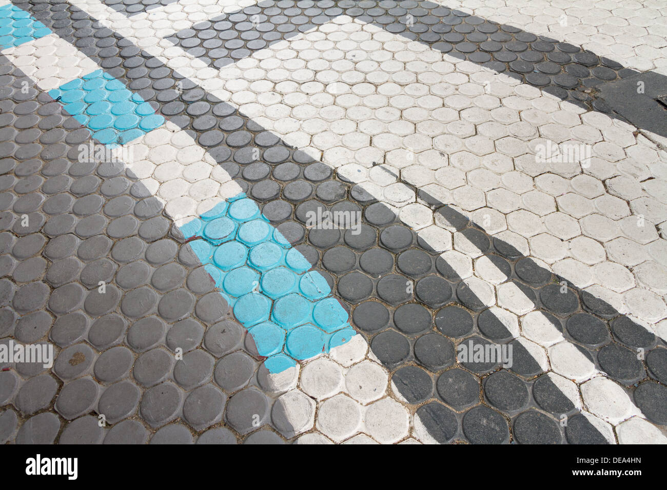 White and blue Traffic Line On Concrete paving block Stock Photo - Alamy