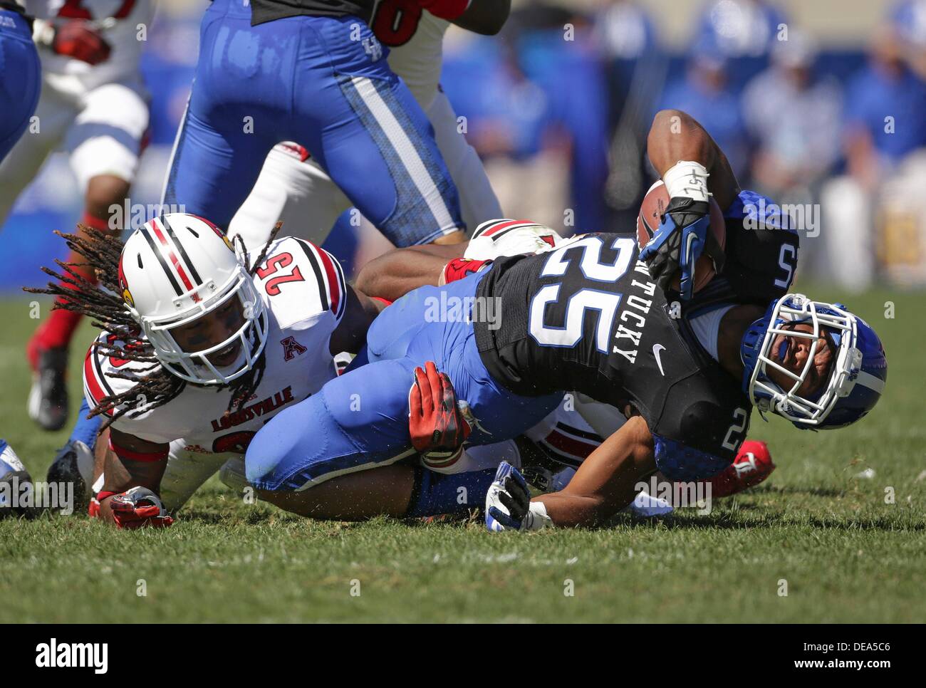UK running back Jonathan George is brought down by U of L safety Calvin ...