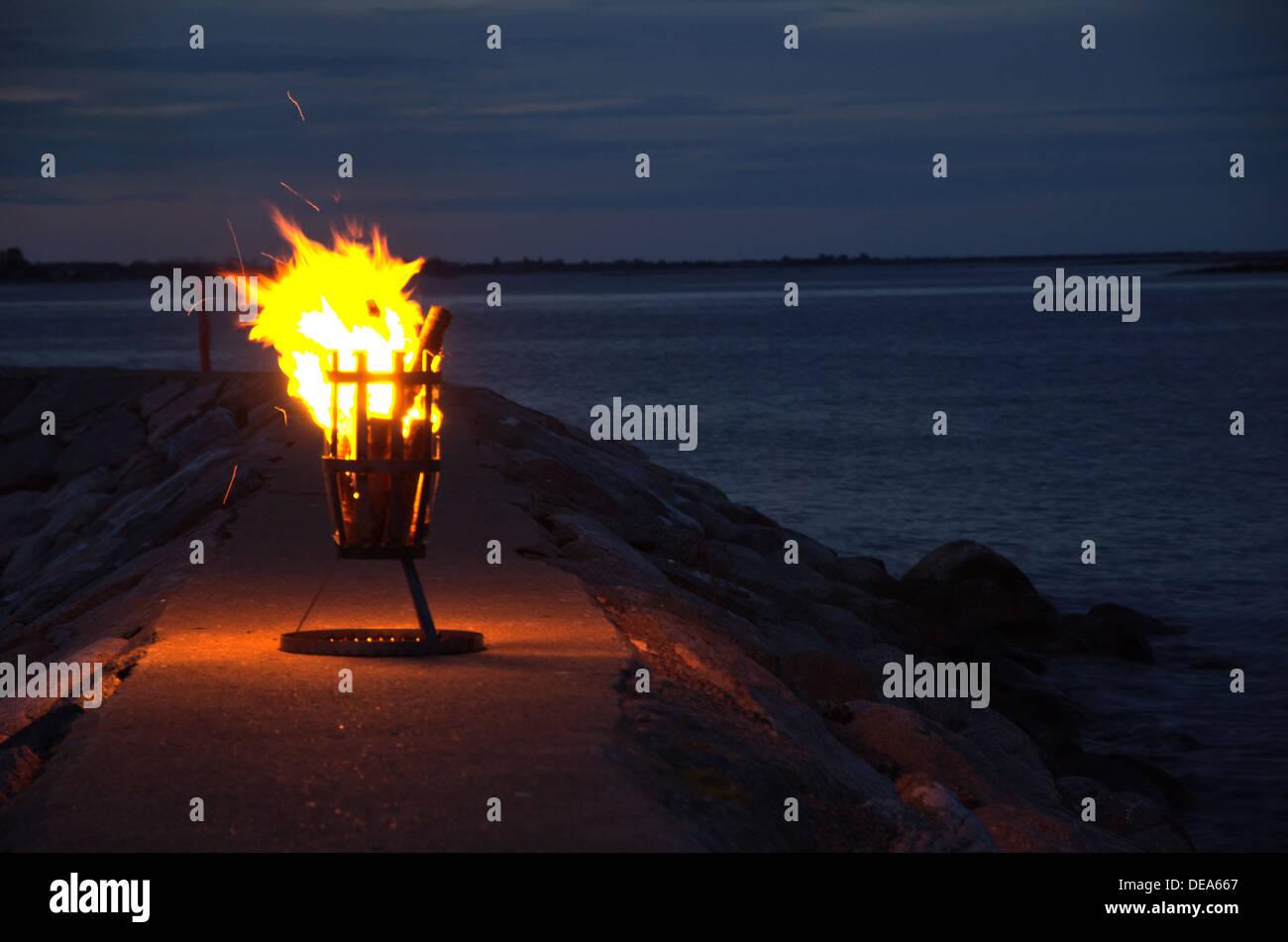 Small bonfire at a harbour pier Stock Photo - Alamy