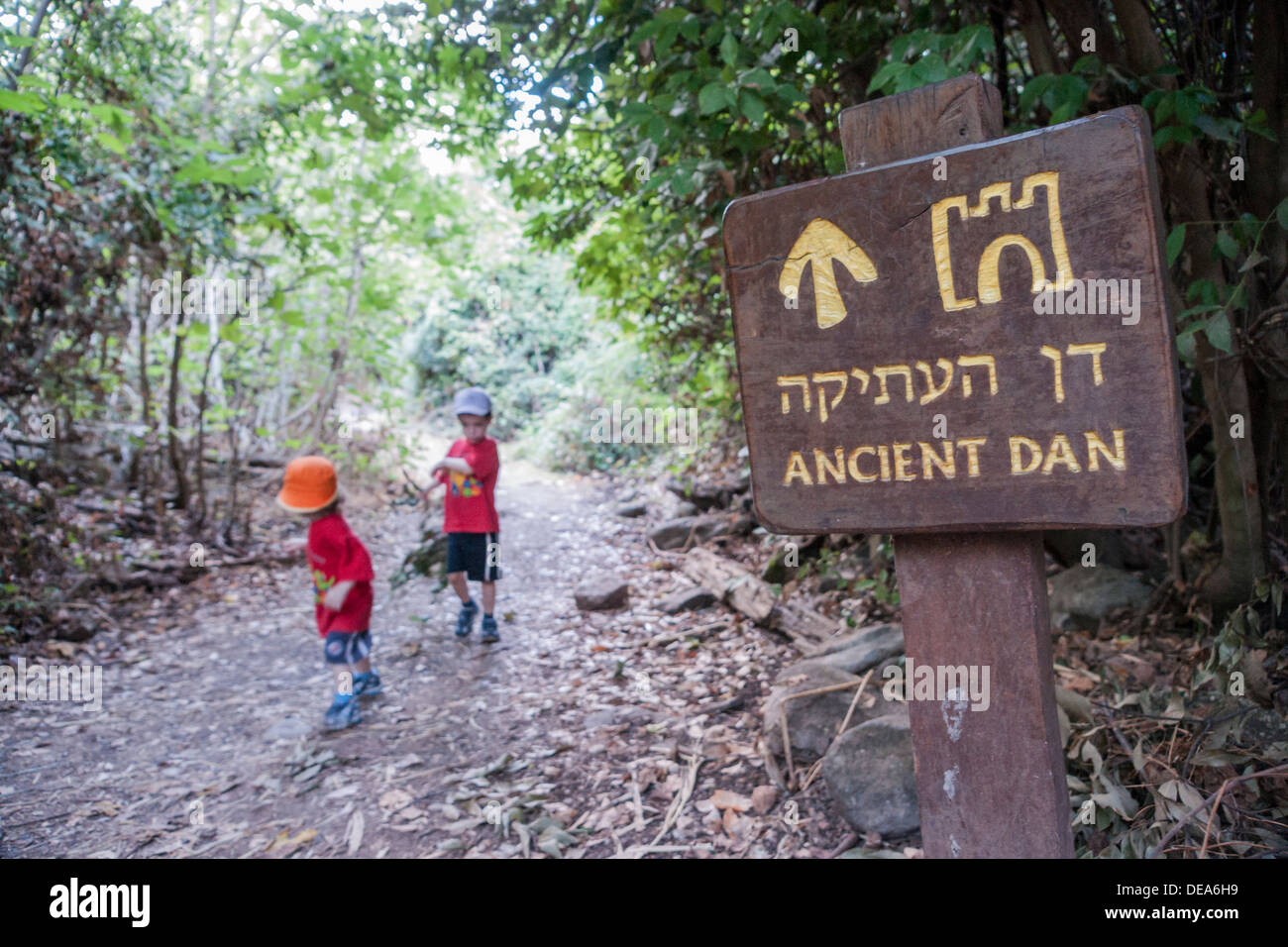 Israel. Kids playing near a sign leading to the ancient village of Dan ...