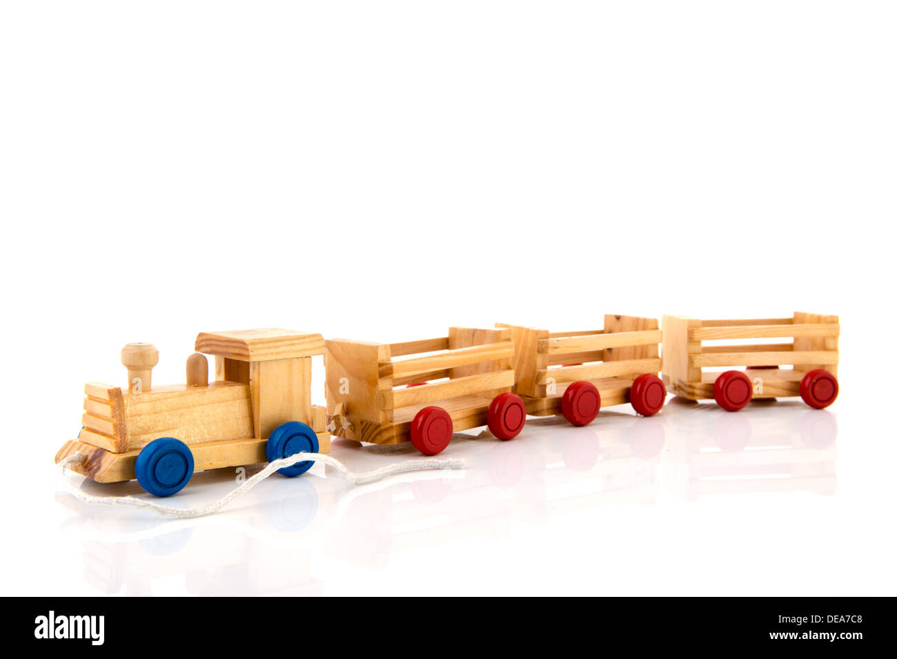Wooden toy train isolated over white background Stock Photo - Alamy