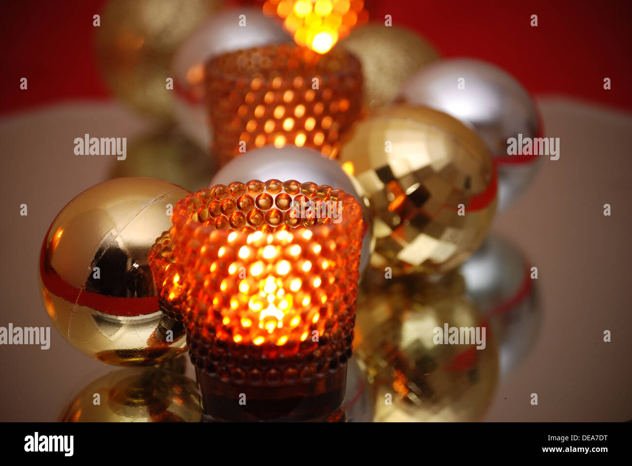 candles and baubles on reflective surface Stock Photo - Alamy