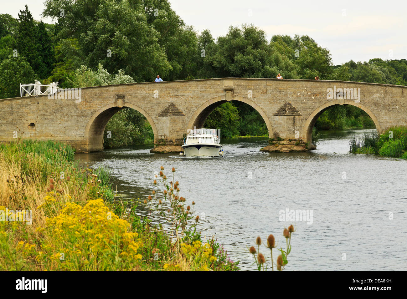 Boat passing underneath Milton Ferry Bridge with people looking and ...