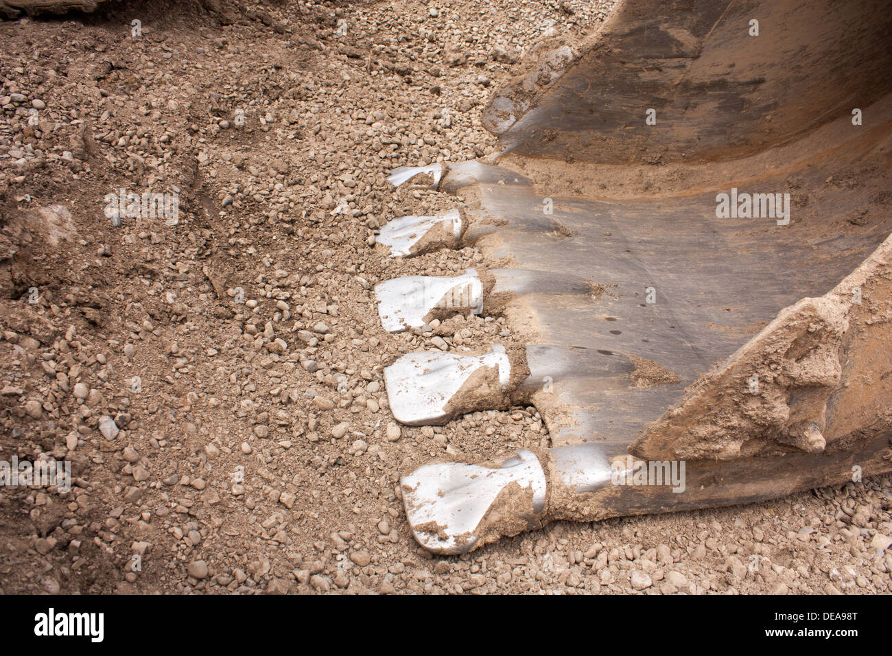 The scoop of the backhoe digs holes and removes dirt, gravel and rocks ...