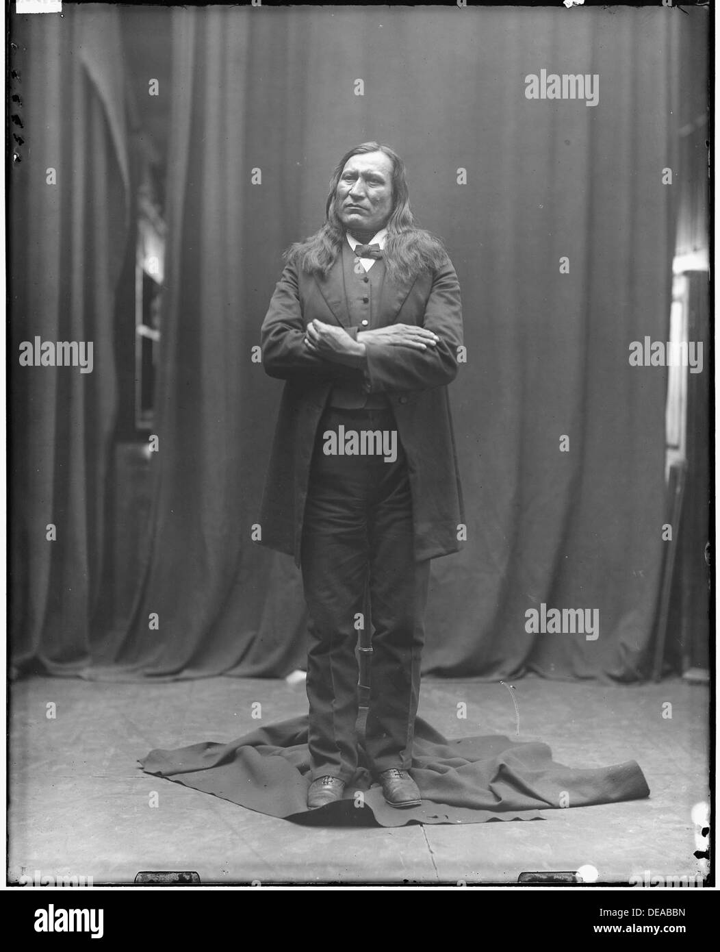 A full-length portrait of a Cheyenne individual, showcasing traditional ...