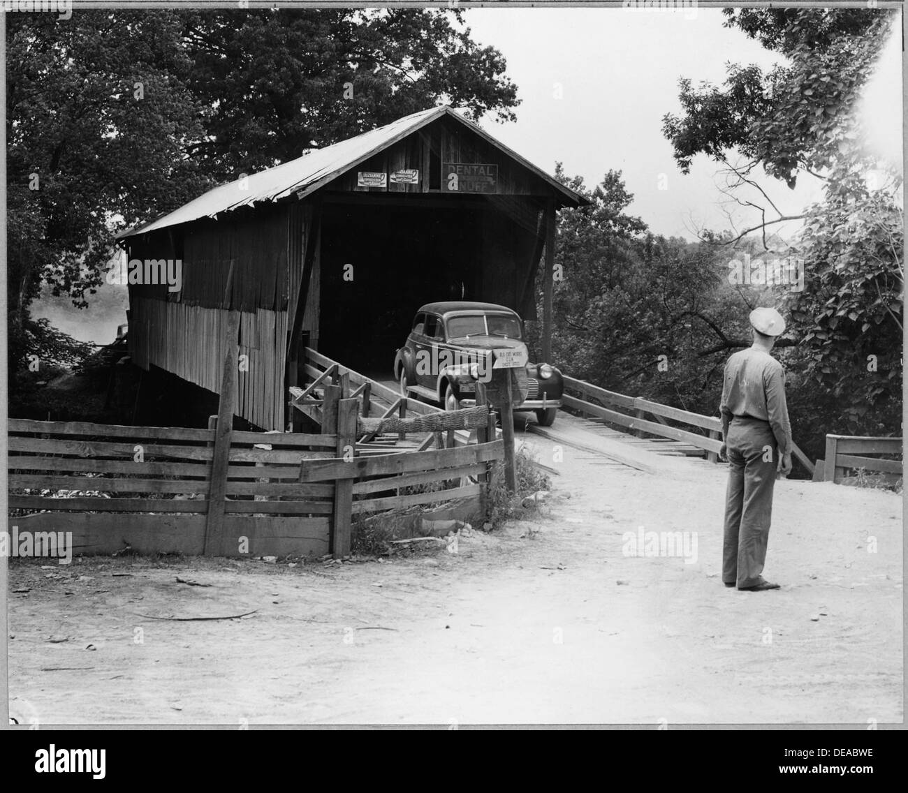 This photograph shows a covered bridge at the entrance to a reservation ...