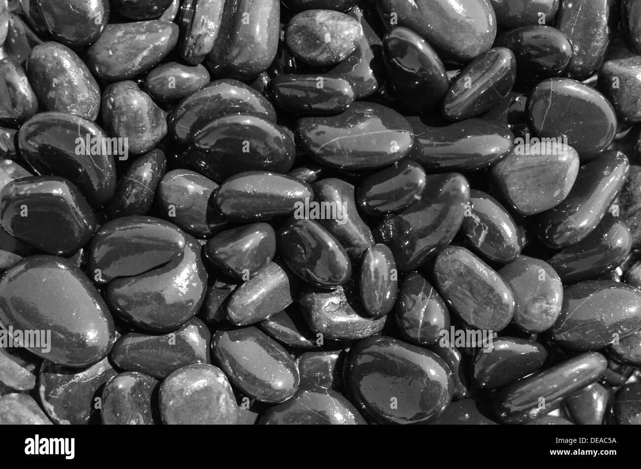 Black pebble stones background Stock Photo - Alamy
