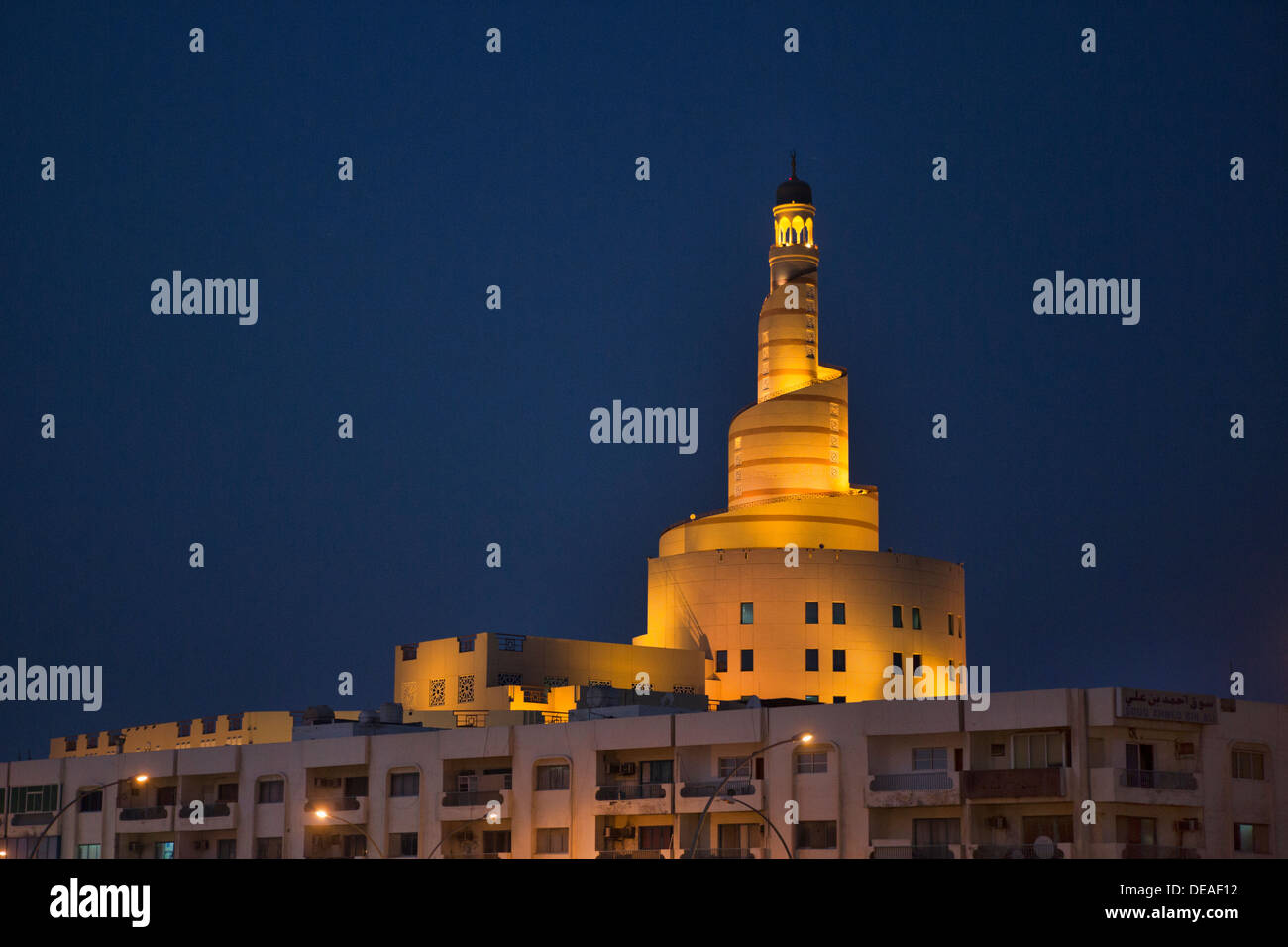 The well lit Spiral Minaret of a Doha, Qatar mosque towers above the ...