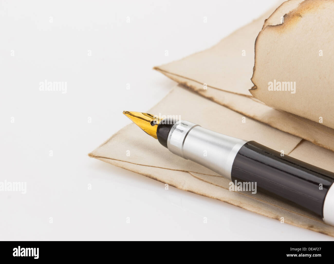ink pen and parchment isolated on white background Stock Photo - Alamy