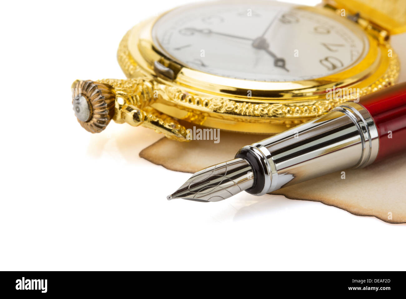 watch and ink pen at vintage parchment isolated on white background ...