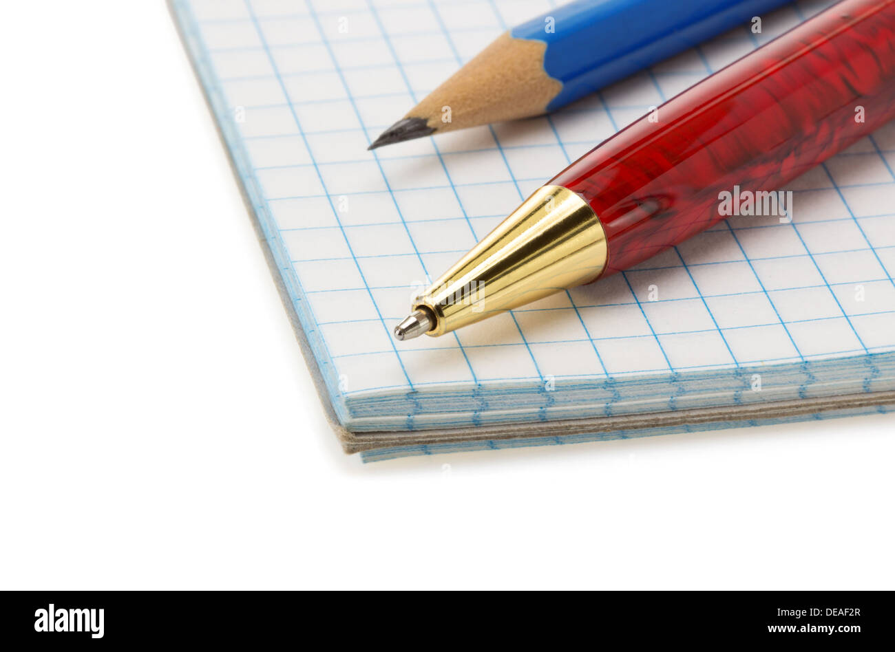 school supplies on checked notebook isolated at white background Stock ...