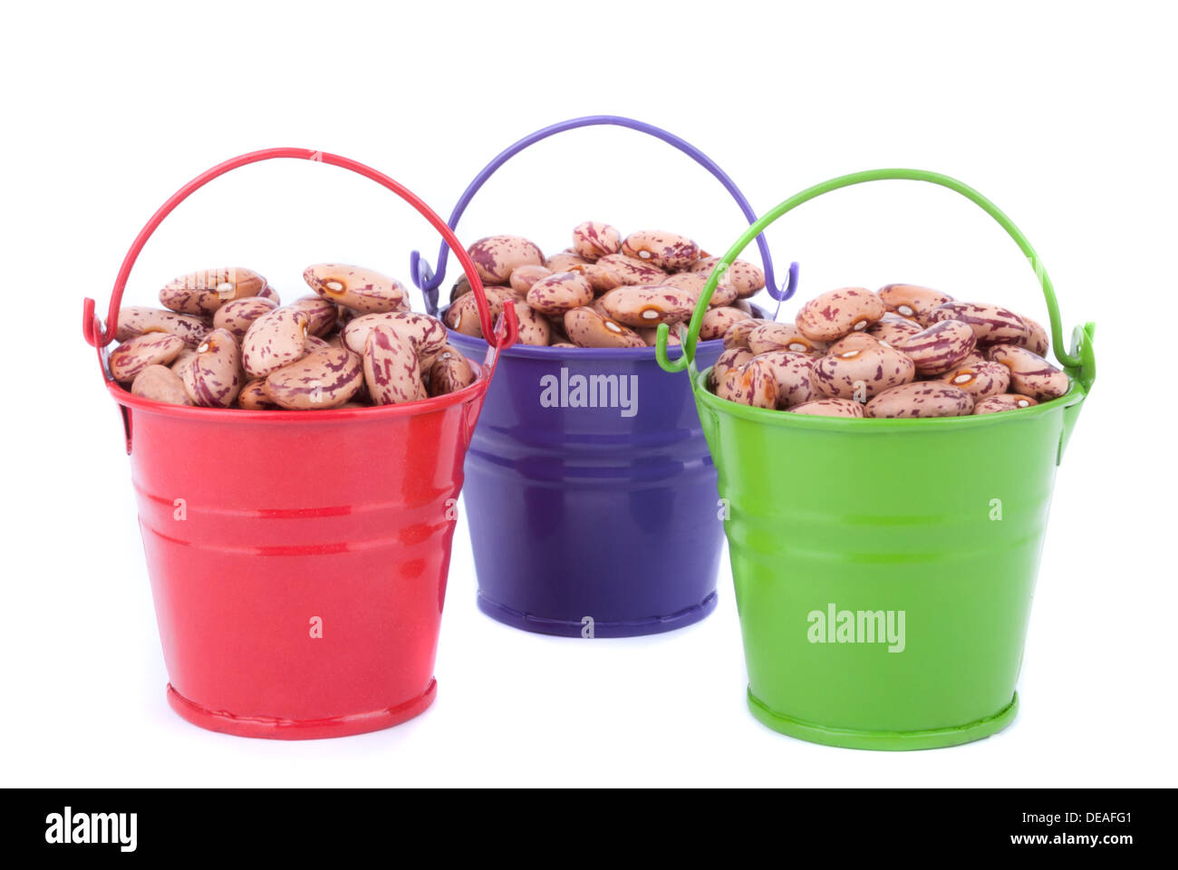 Multicolored buckets with beans on a white background Stock Photo - Alamy