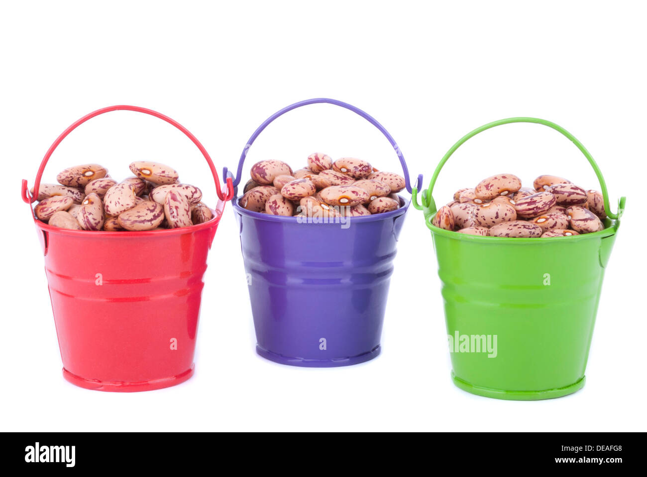Multicolored buckets with beans on a white background Stock Photo - Alamy