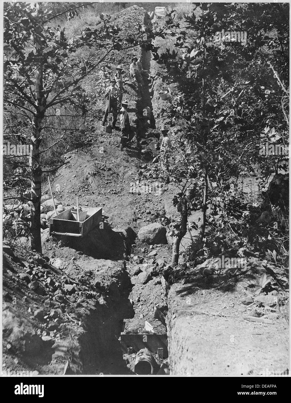 A photograph of workers laying a siphon pipe at the La Jolla ...