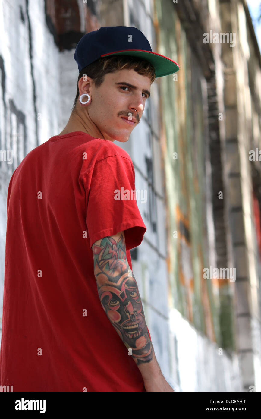 A young Rapper walking down a urban street Stock Photo - Alamy