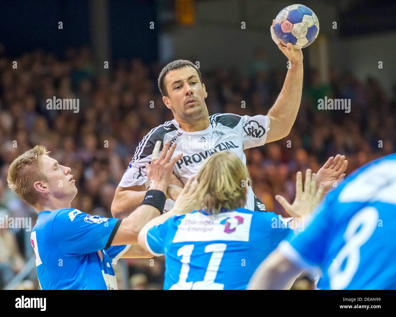 Kiel's Marko Vujin in action against Eisenach's Daniel Luther (L) and ...
