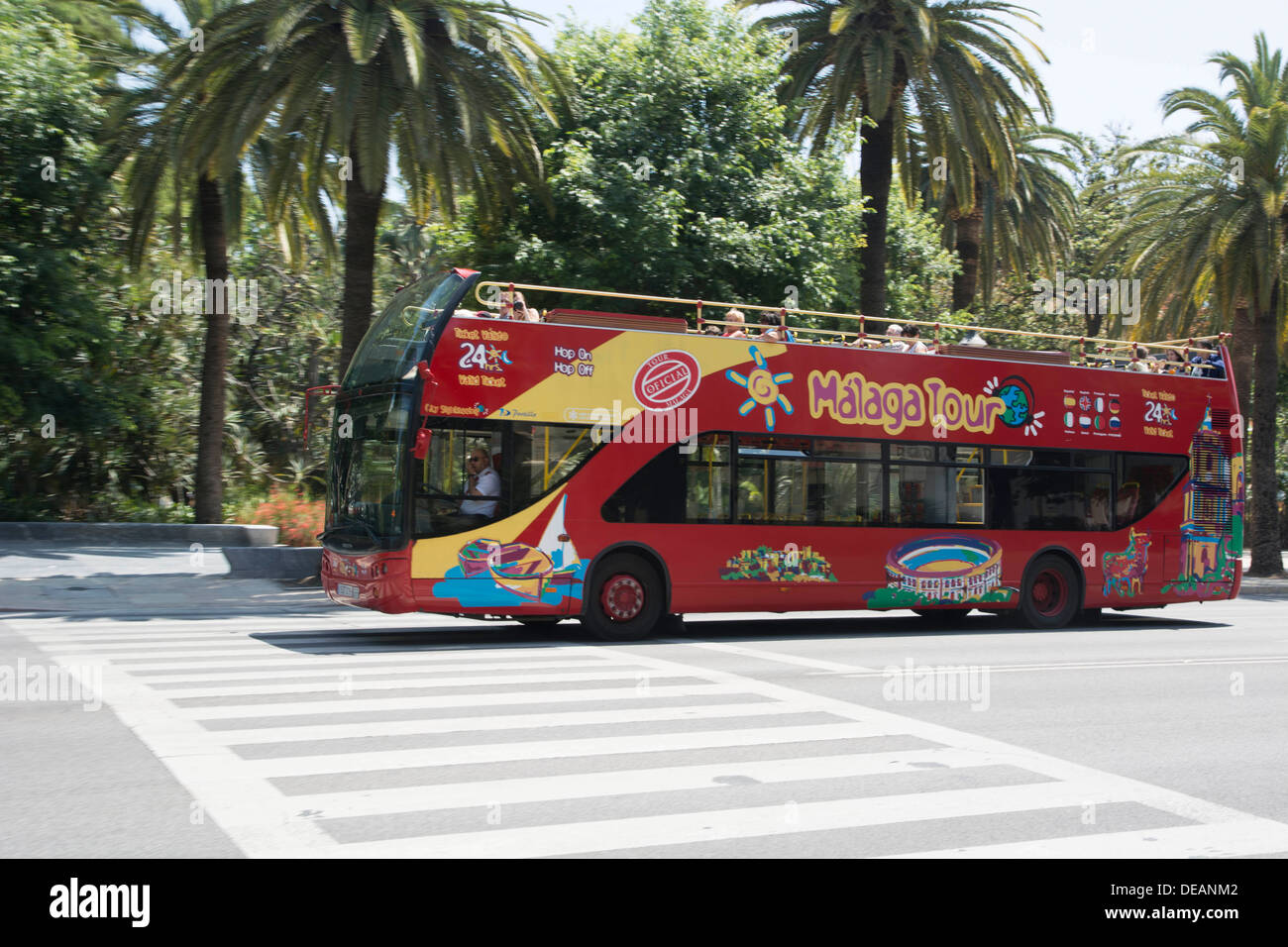 Red Spanish city bus travelling along main Avenida Stock Photo - Alamy