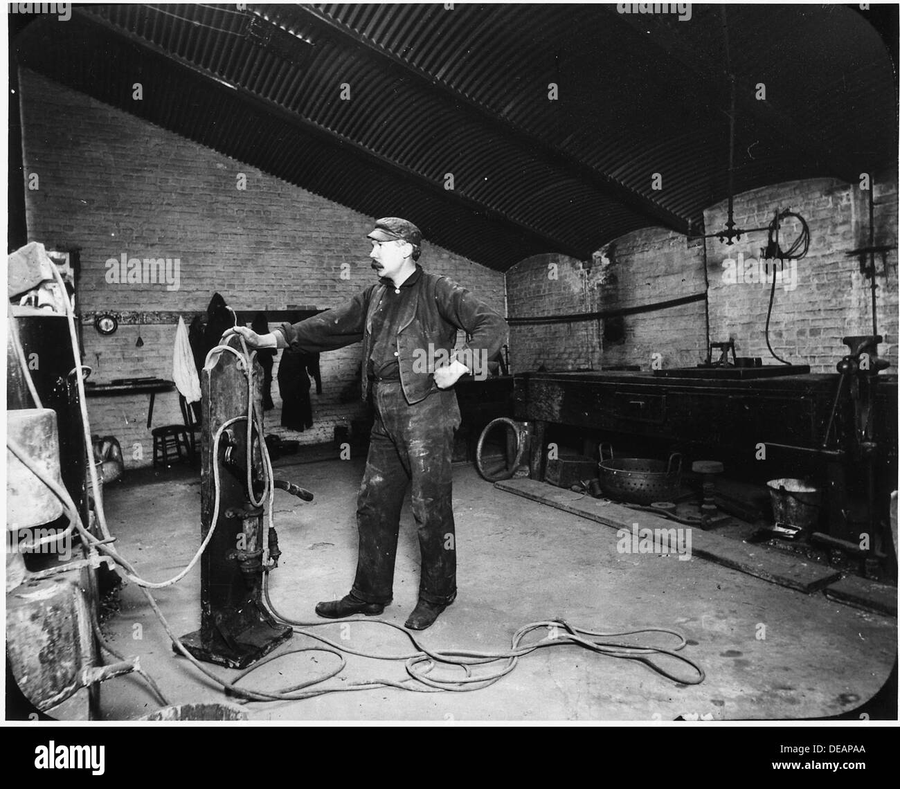 The photograph shows a San Francisco Mint employee working in an attic ...