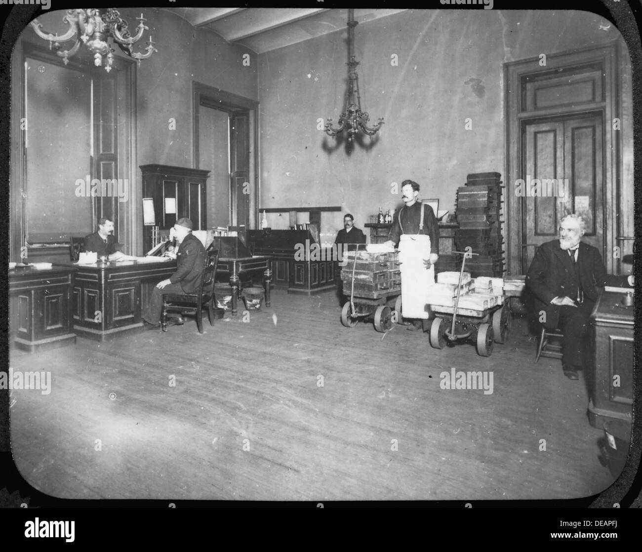 This photograph shows five employees working at the San Francisco Mint ...