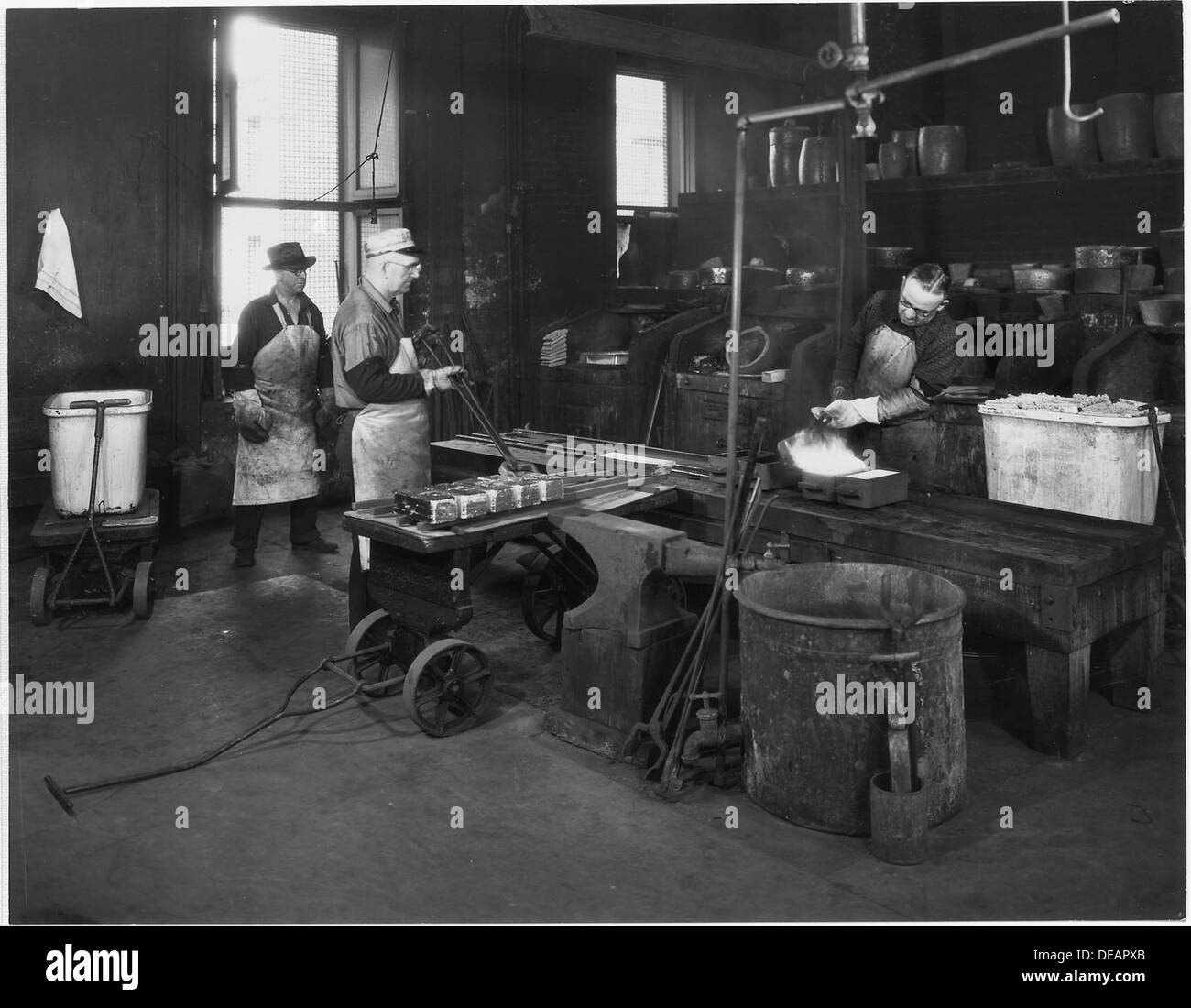 This photograph shows the process of treating gold in a refinery, where ...