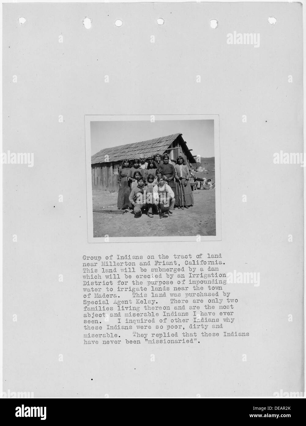 A photograph of a group of Native Americans standing on land near ...