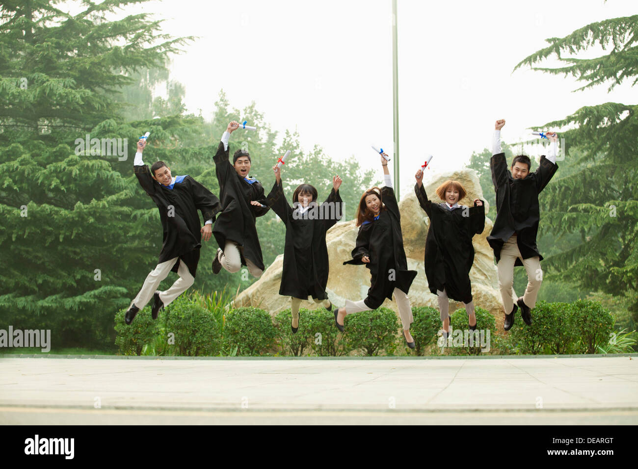 Young Group of Graduates Jumping Stock Photo - Alamy