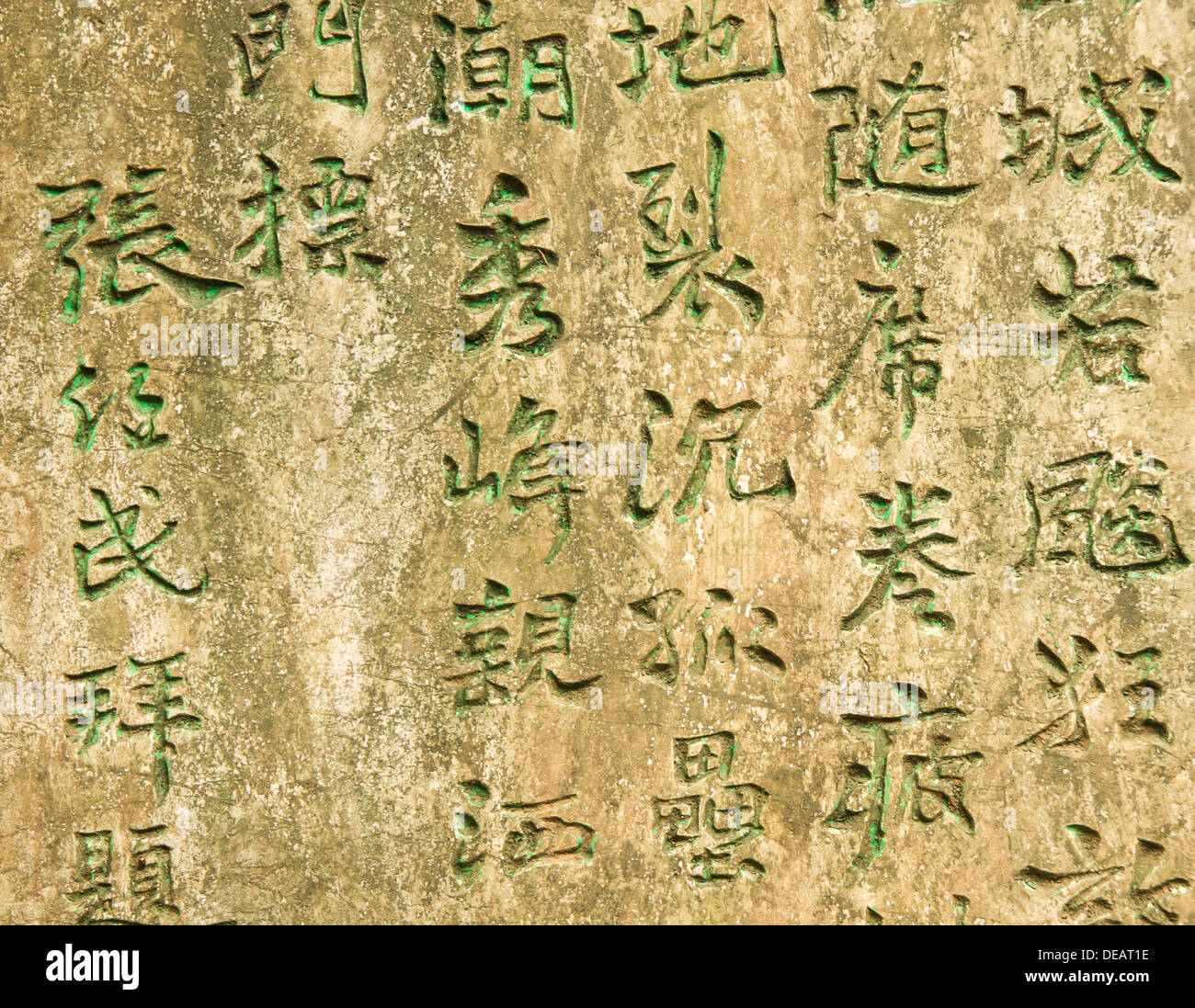 Ancient worn wall full of green chinese text Stock Photo - Alamy