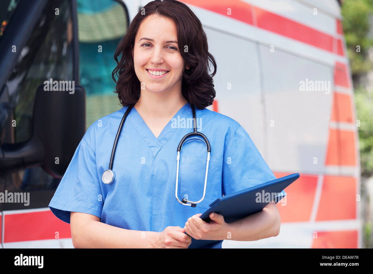 Portrait of smiling female paramedic in front of am ambulance Stock ...