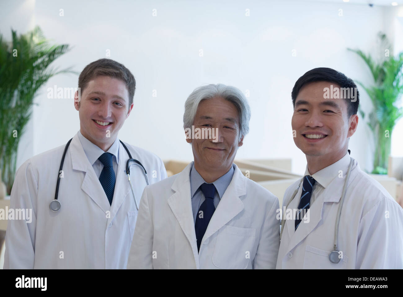 Portrait of three smiling doctors in the hospital, multi-ethnic group ...