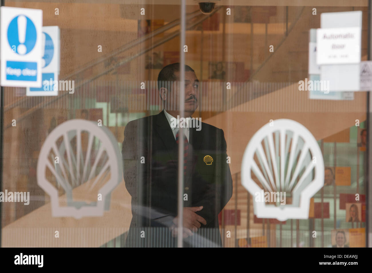 London, UK. 15 September 2013. Shell security guard looks out of Shell ...