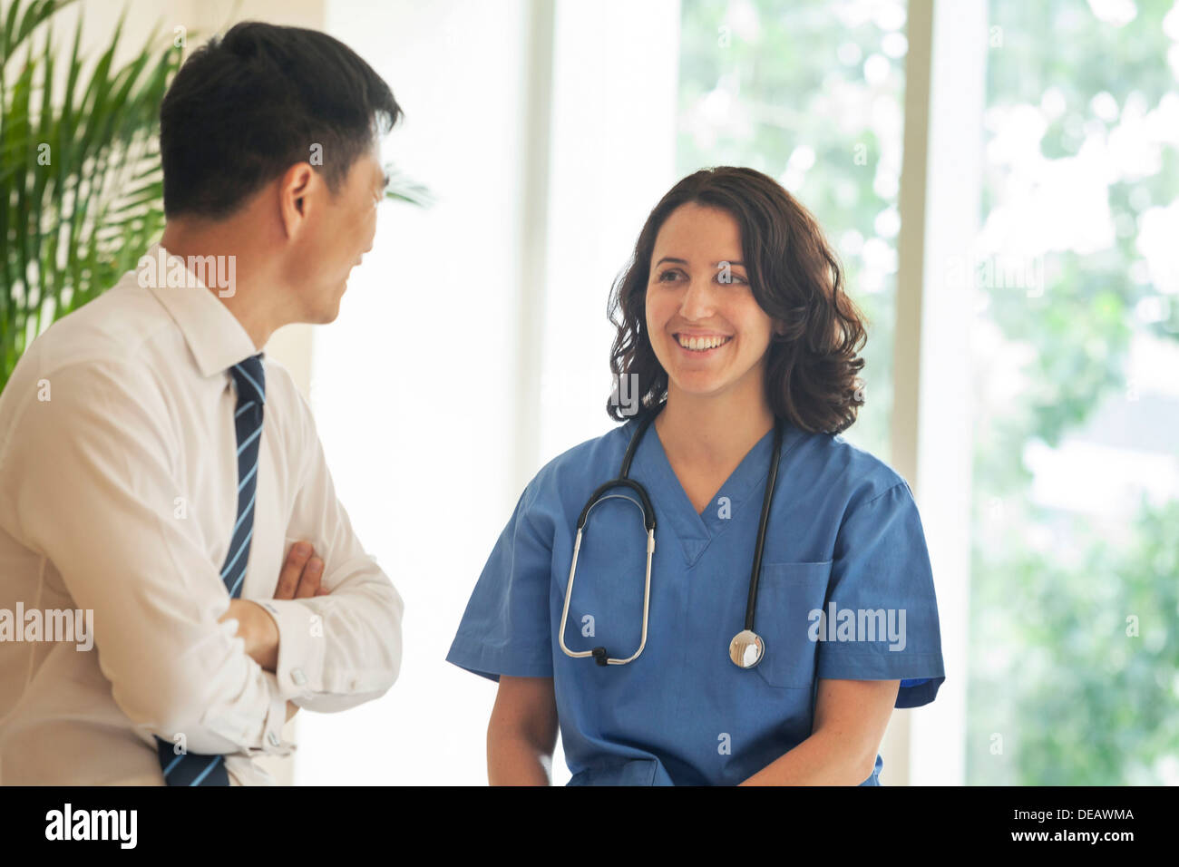 Female nurse and patient talking and smiling in the hospital Stock ...