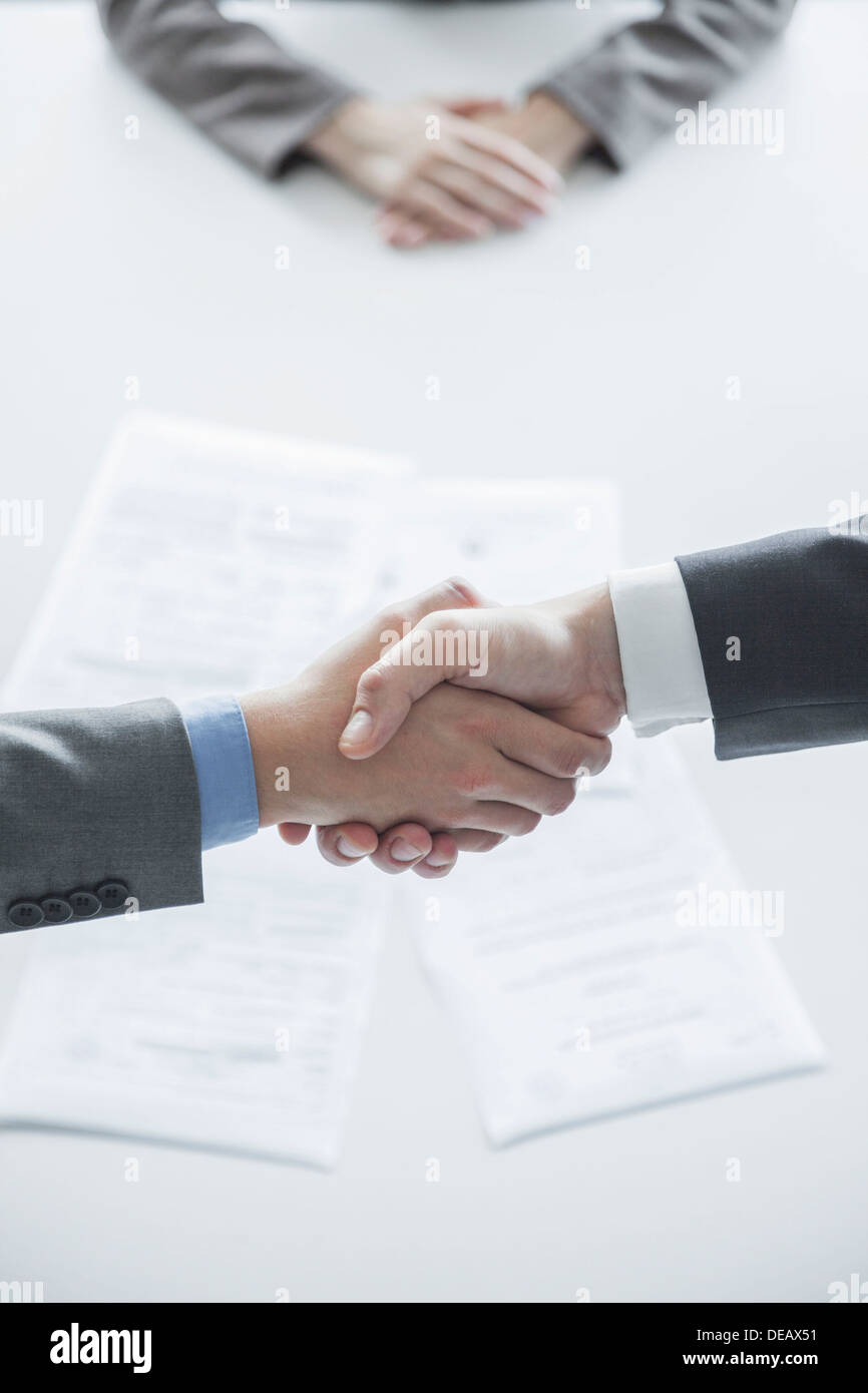 Two business people shaking hands over the table, hands only Stock ...