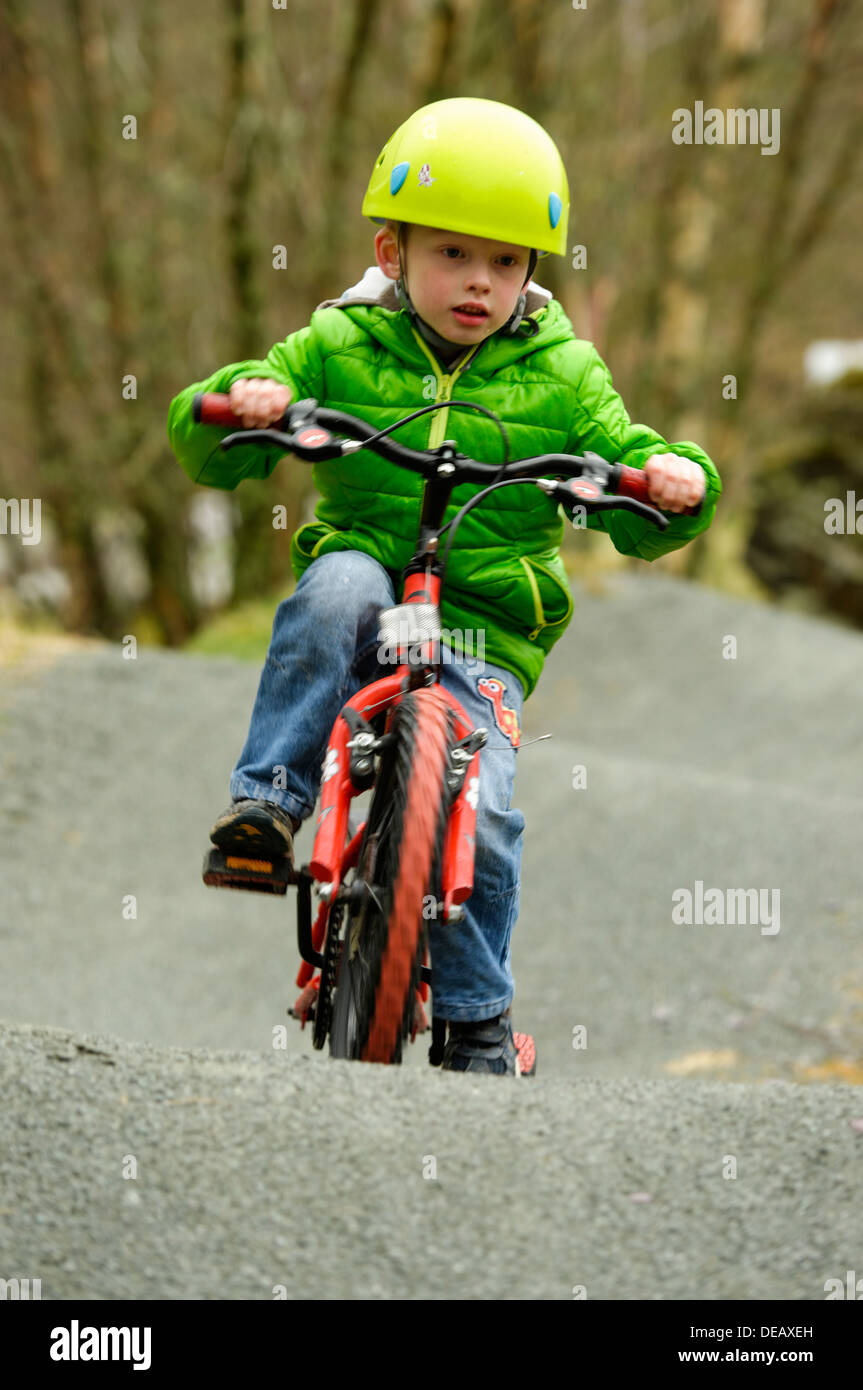 A young boy riding on a mountain bike track Stock Photo - Alamy